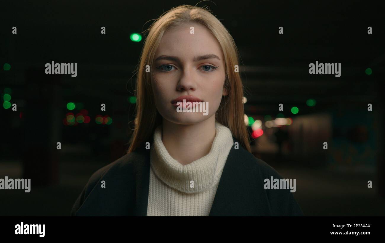 Calm lady Caucasian woman stand alone on dark parking background ...