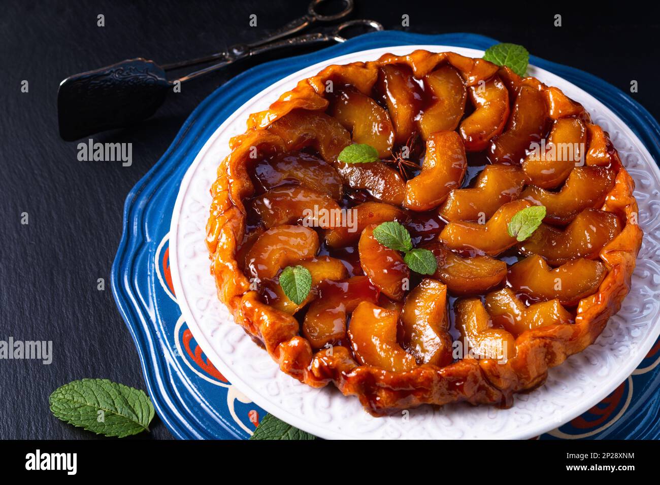 Food concept homemade tarte tatin upside down apple tart pie on black ...