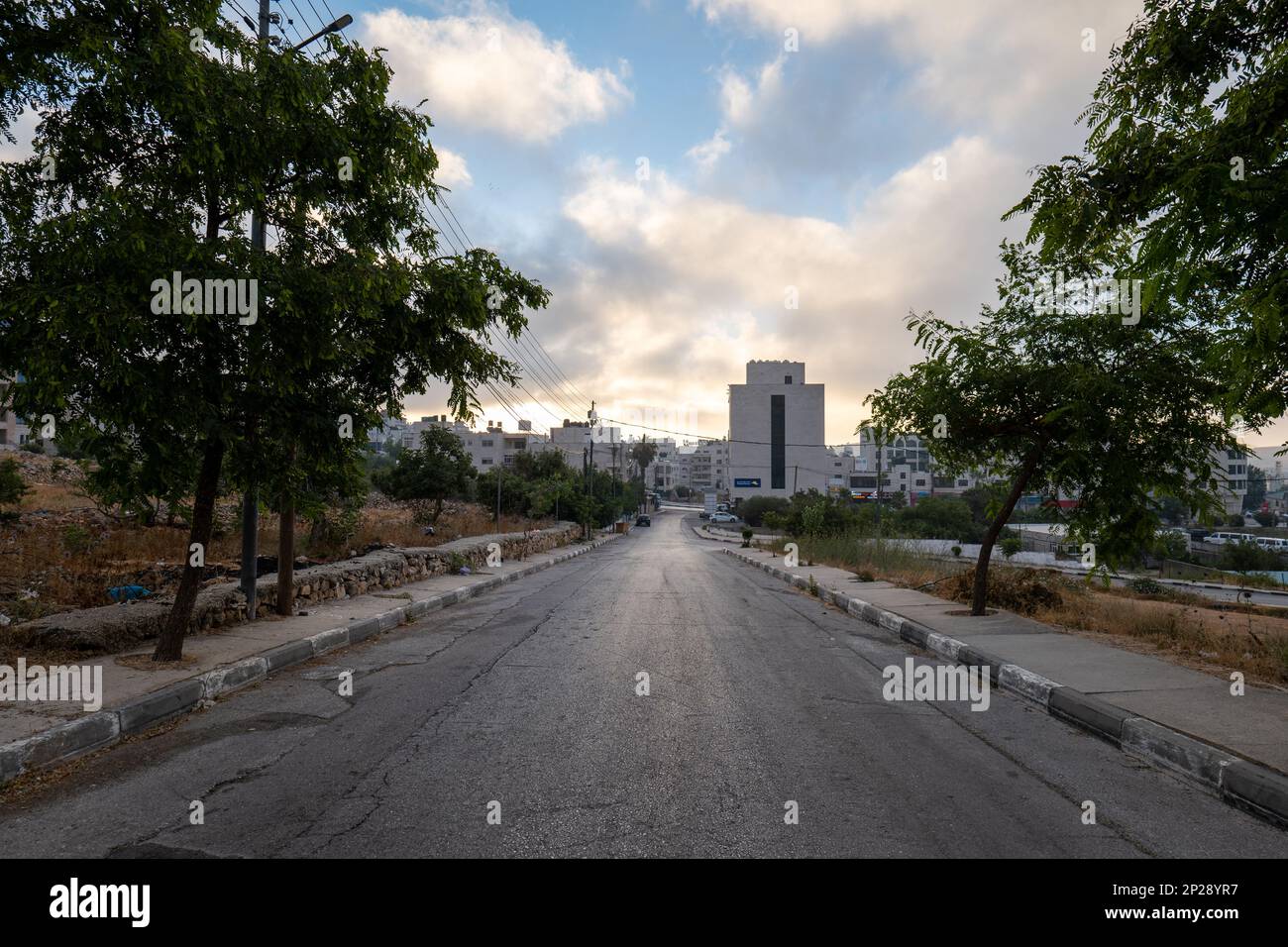 Wide View of Ramallah Empty Street at Dawn with Buildings and Trees ...
