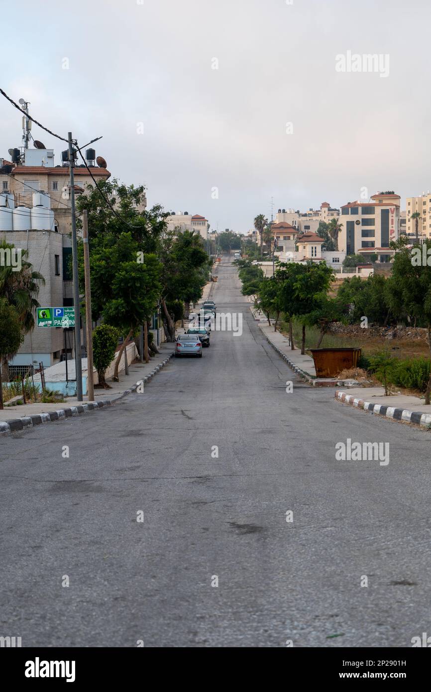 Vertical View of Quiet Ramallah Empty Street at Dawn with Buildings and ...