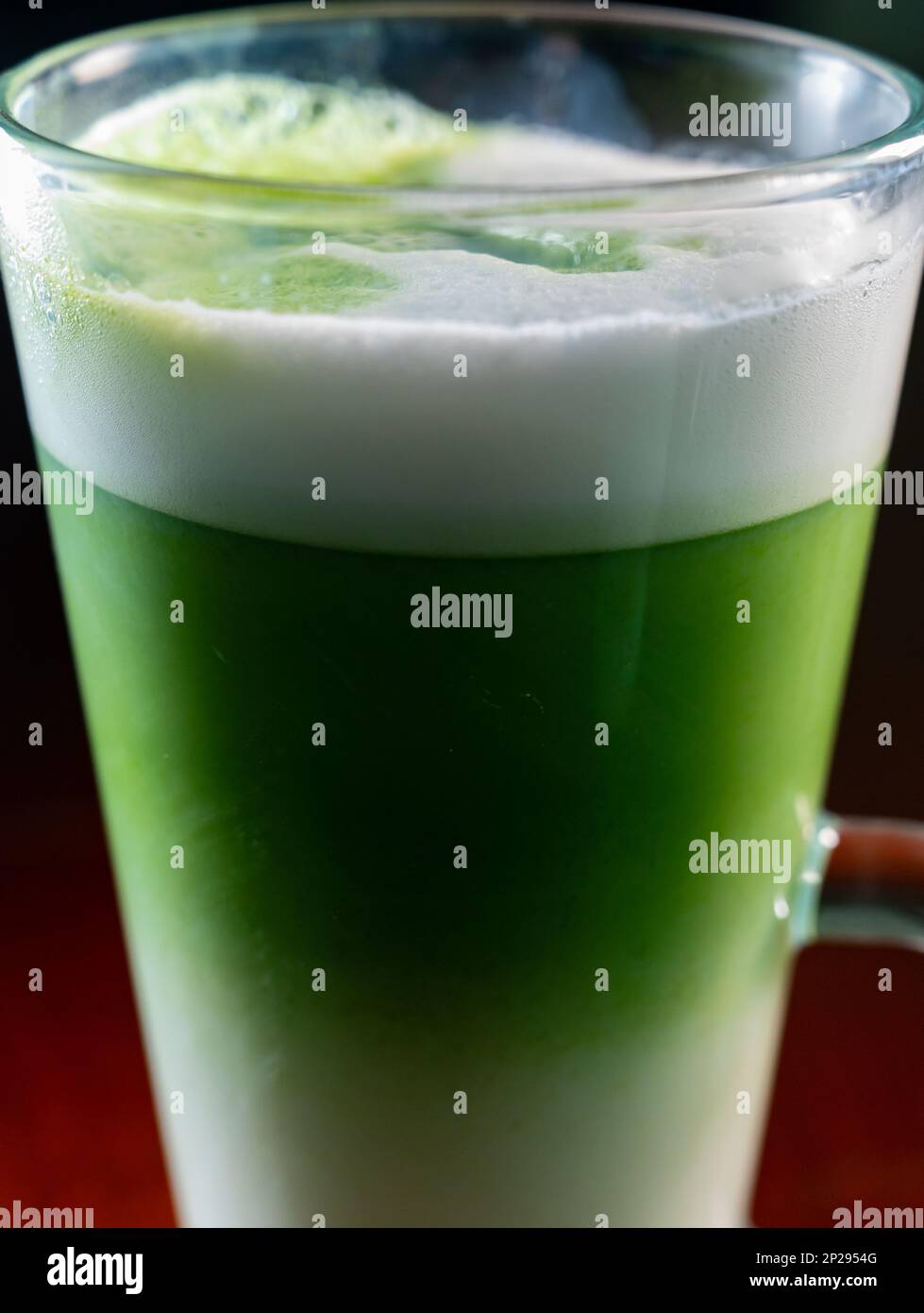 Glass of green Matcha tea made from finely ground powder of specially ...