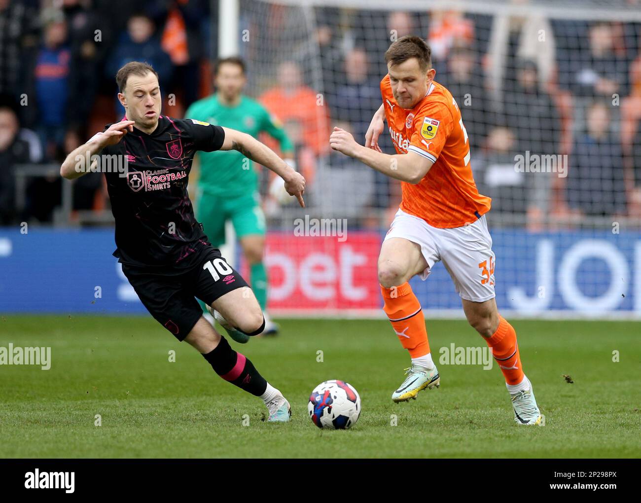 Burnley's Ashley Barnes (left) and Blackpool's Jordan Thorniley battle ...