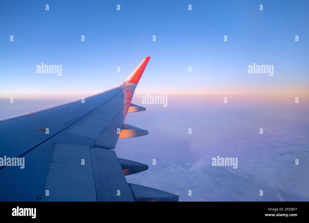 Airplane flying in the sky, view to thу aircraft wing through a window ...