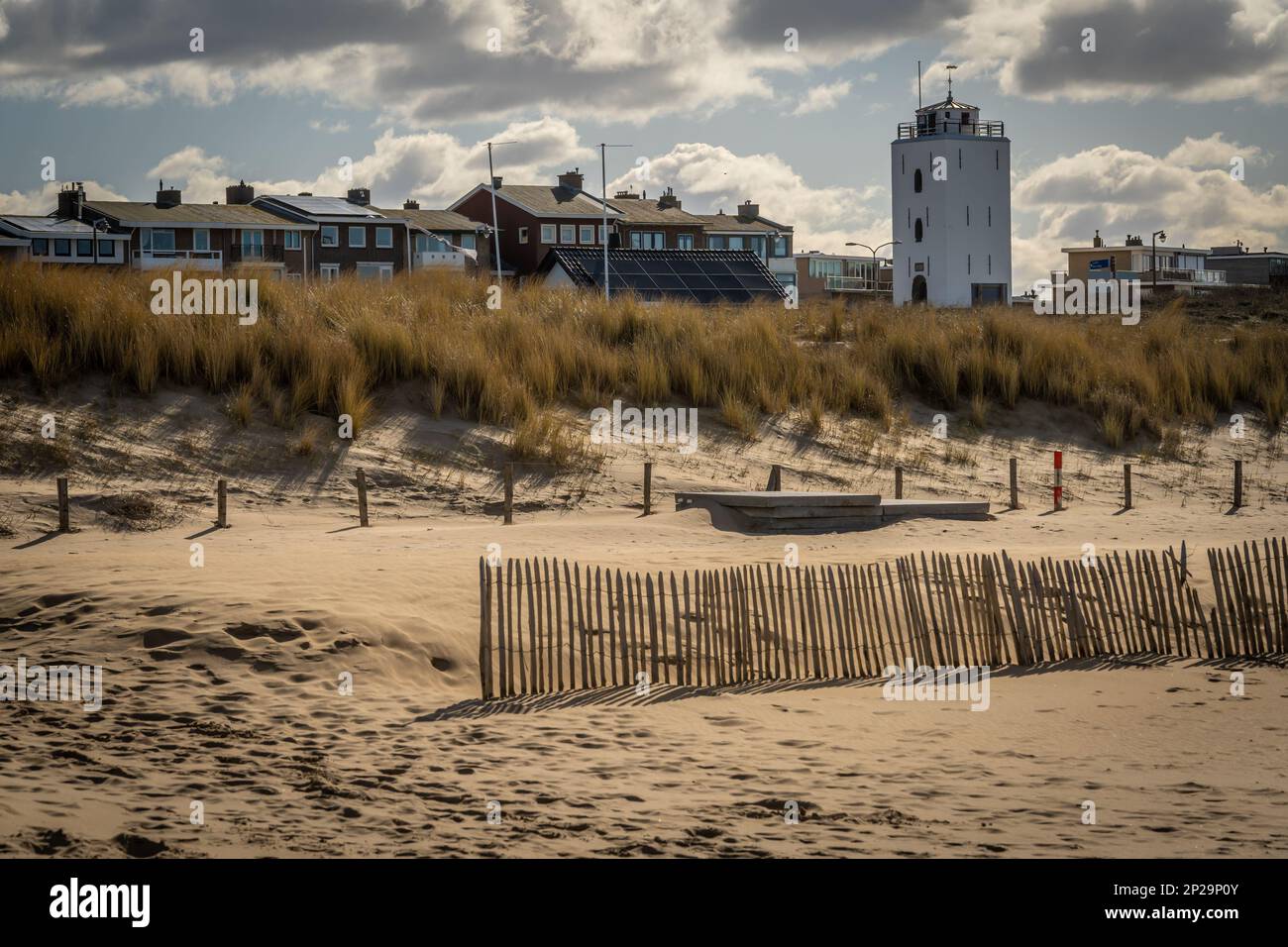 White lighthouse at seaside resort Katwijk aan Zee seen from sandy ...