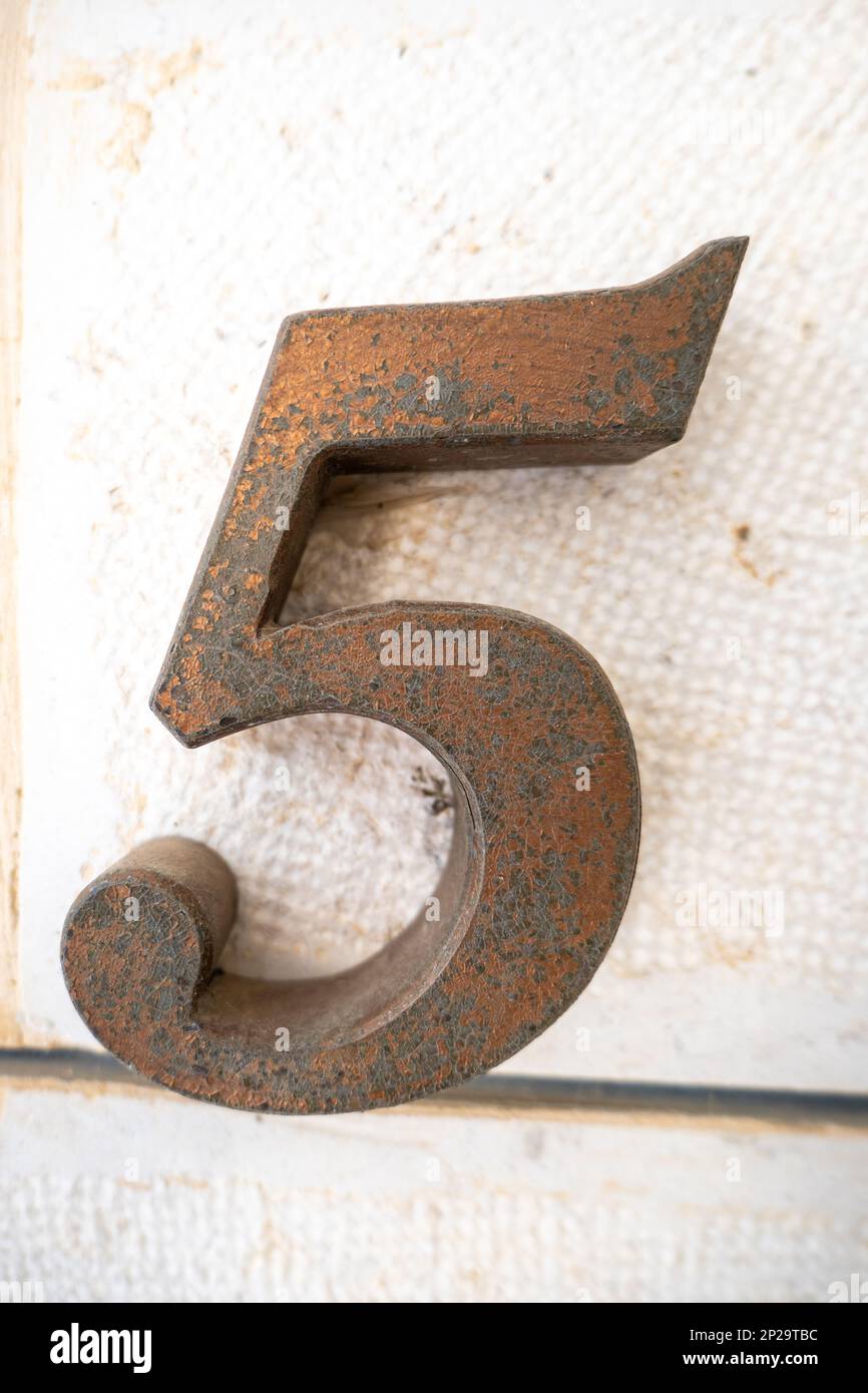Large Golden Five Symbol on a White Wall Stock Photo - Alamy