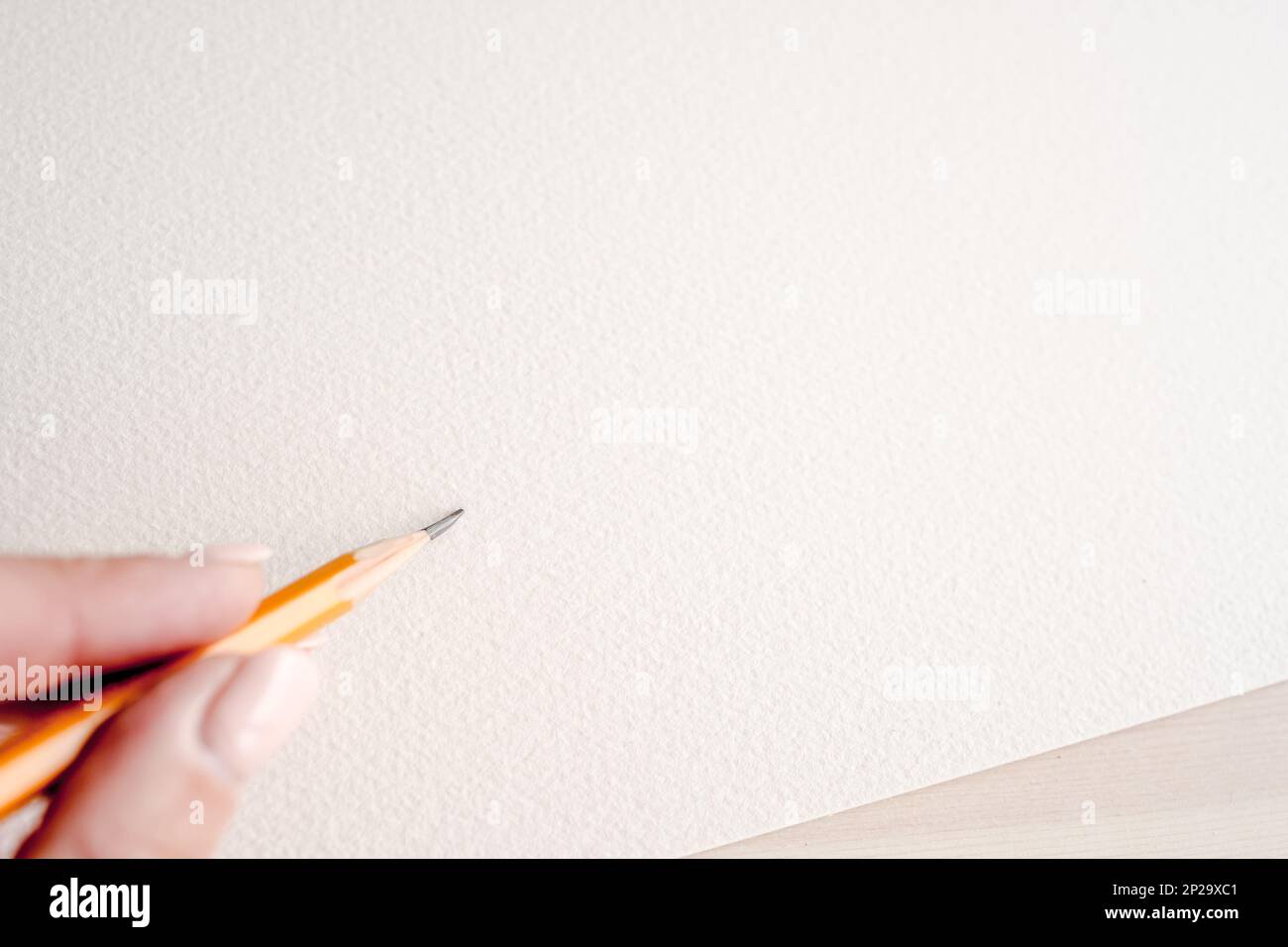Girl hand holding graphite pencil Stock Photo - Alamy