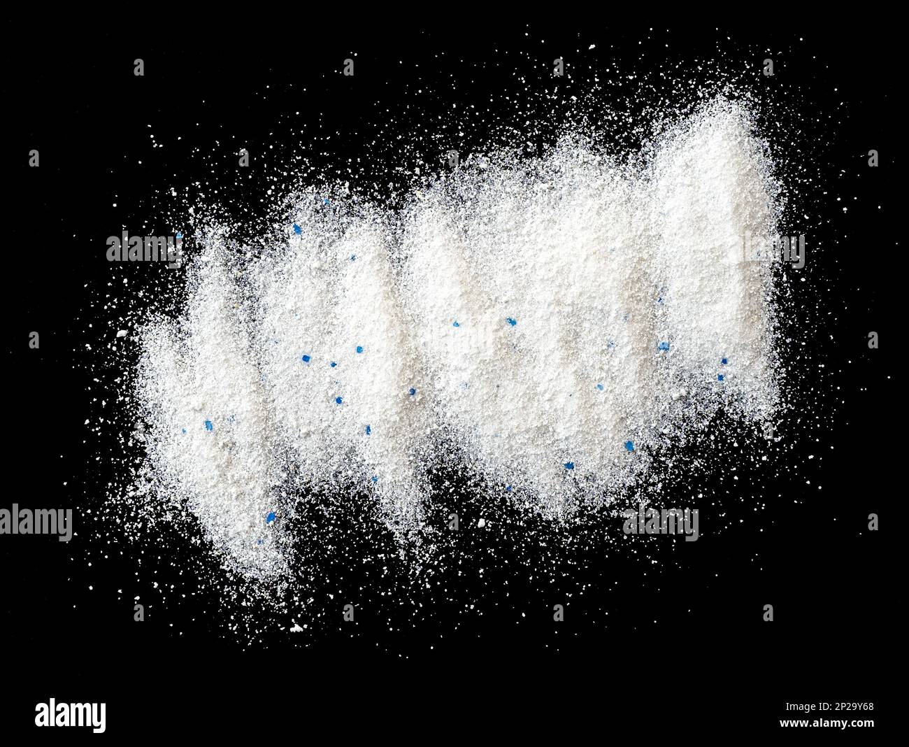 Pile of washing powder or laundry detergent isolated on black, top view ...