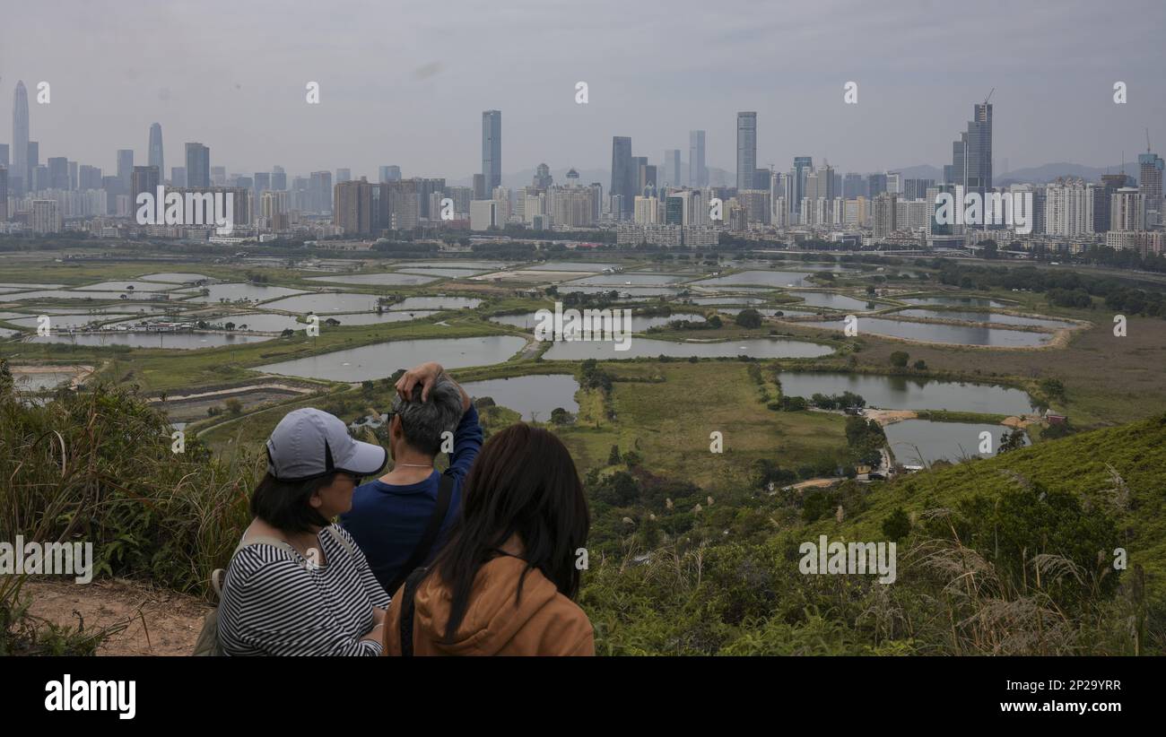 People hiking in Ma Tso Lung at Lok Ma Chau. The background is the view ...