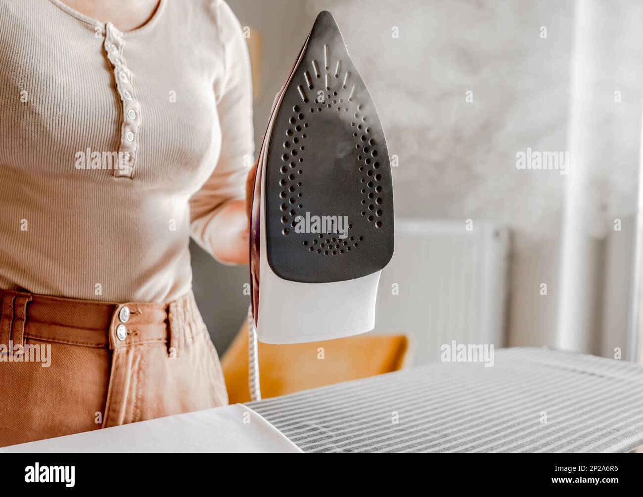 Girl hand using iron hi-res stock photography and images - Alamy