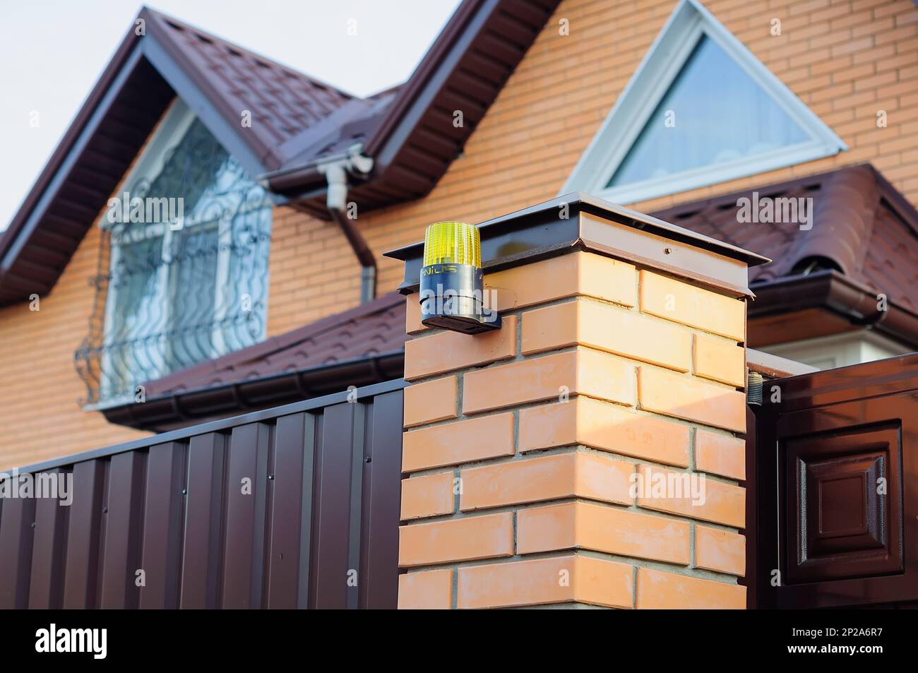 Gate opening sensor for a car on a brick post. Entrance to the yard of ...