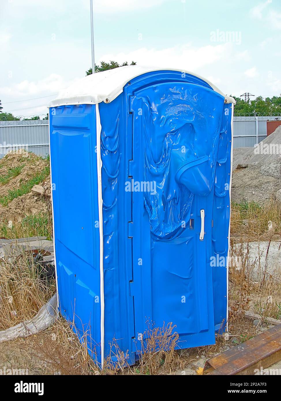 Cabin of a blue bio-toilet that melted from a fire. Melted plastic ...