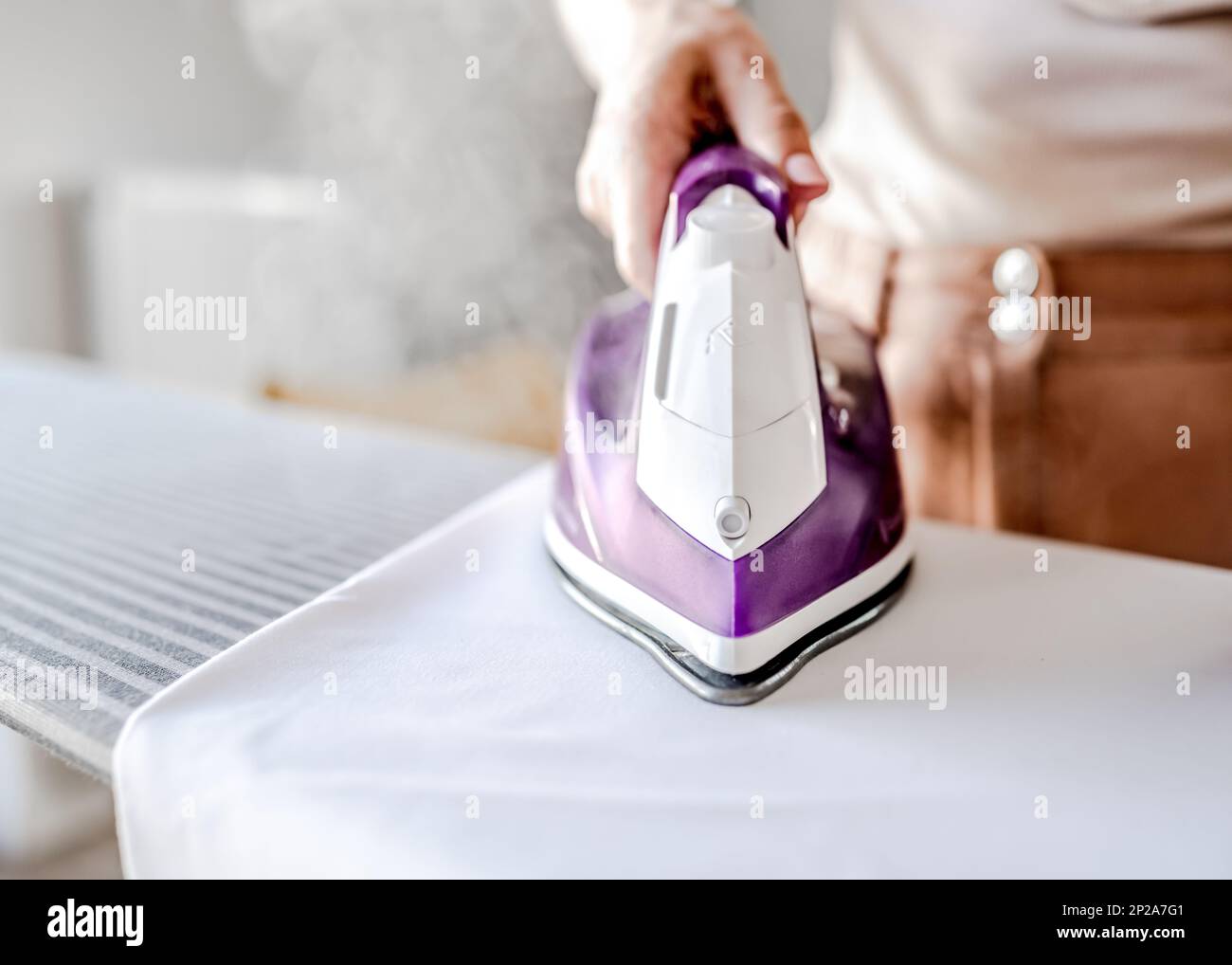 Female hand using steam iron hi-res stock photography and images - Alamy