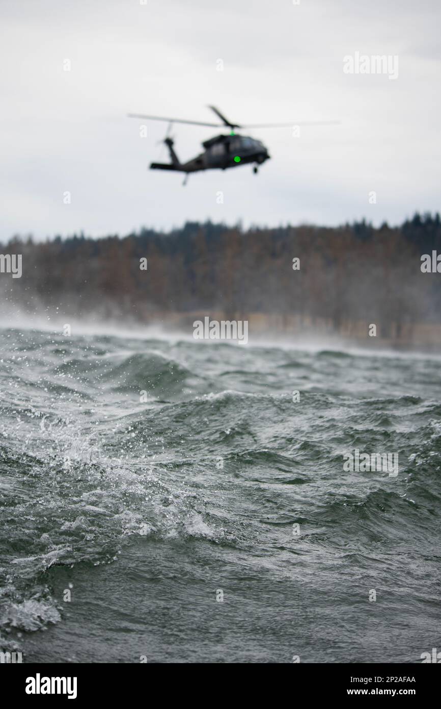 A 305th Rescue Squadron HH HH-60G Pave Hawk helicopter hovers over a ...