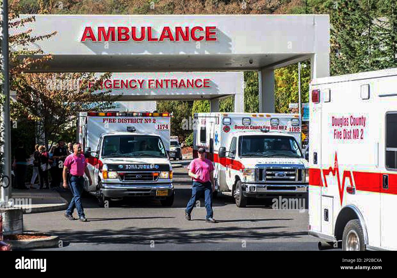 Paramedics return to their ambulances after delivering patients to ...