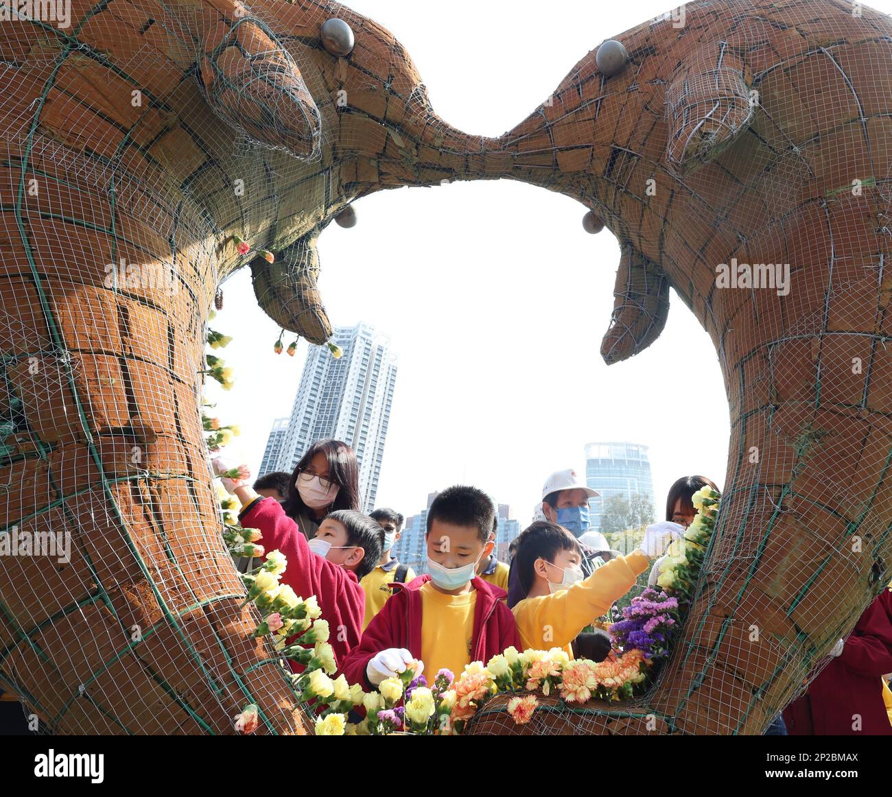 Students of the Hong Chi Morninghope School, Tuen Mun decorate flowers ...