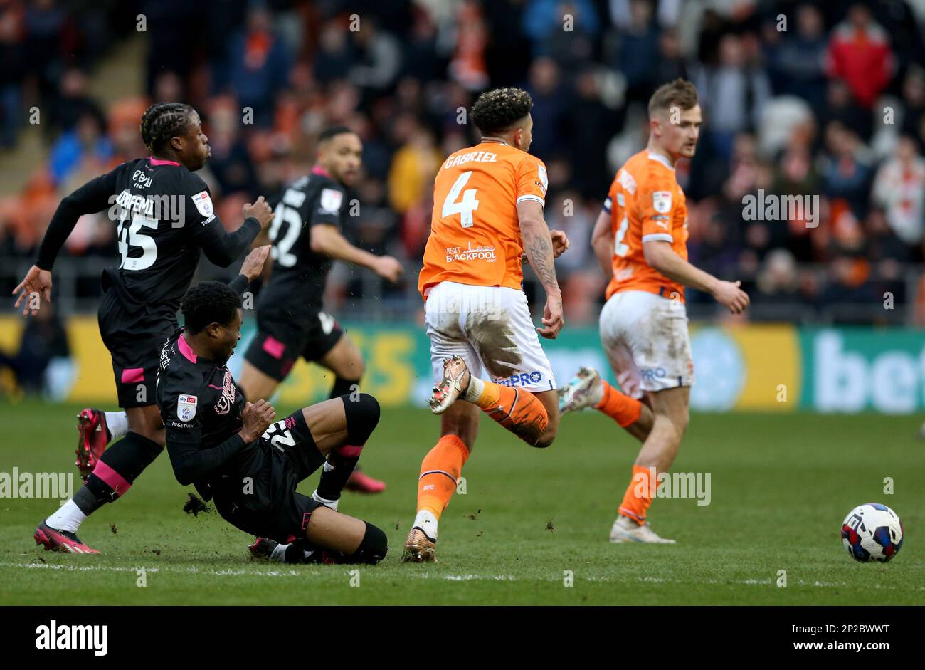 Burnley's Nathan Tella (centre left) fouls Blackpool's Jordan Lawrence ...