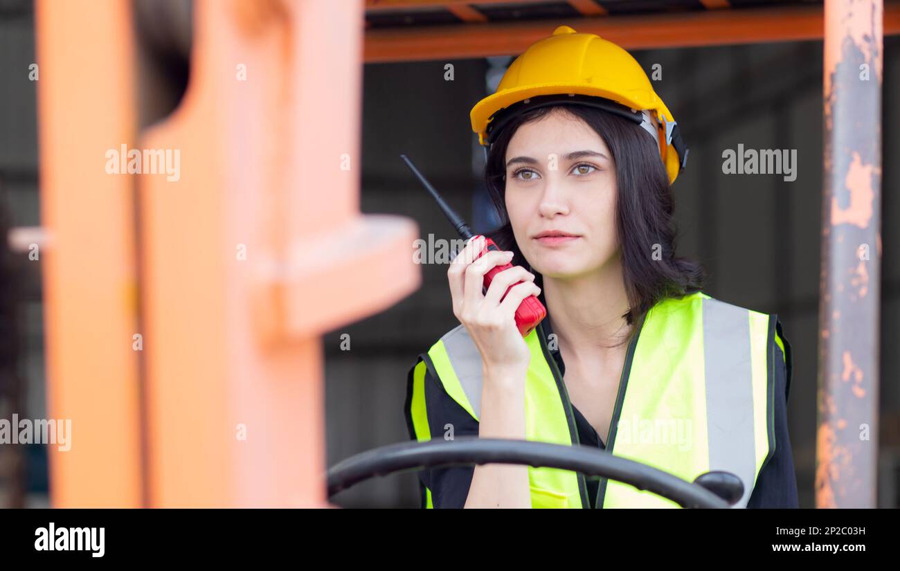 Young asian woman is foreman using radio for communication while ...