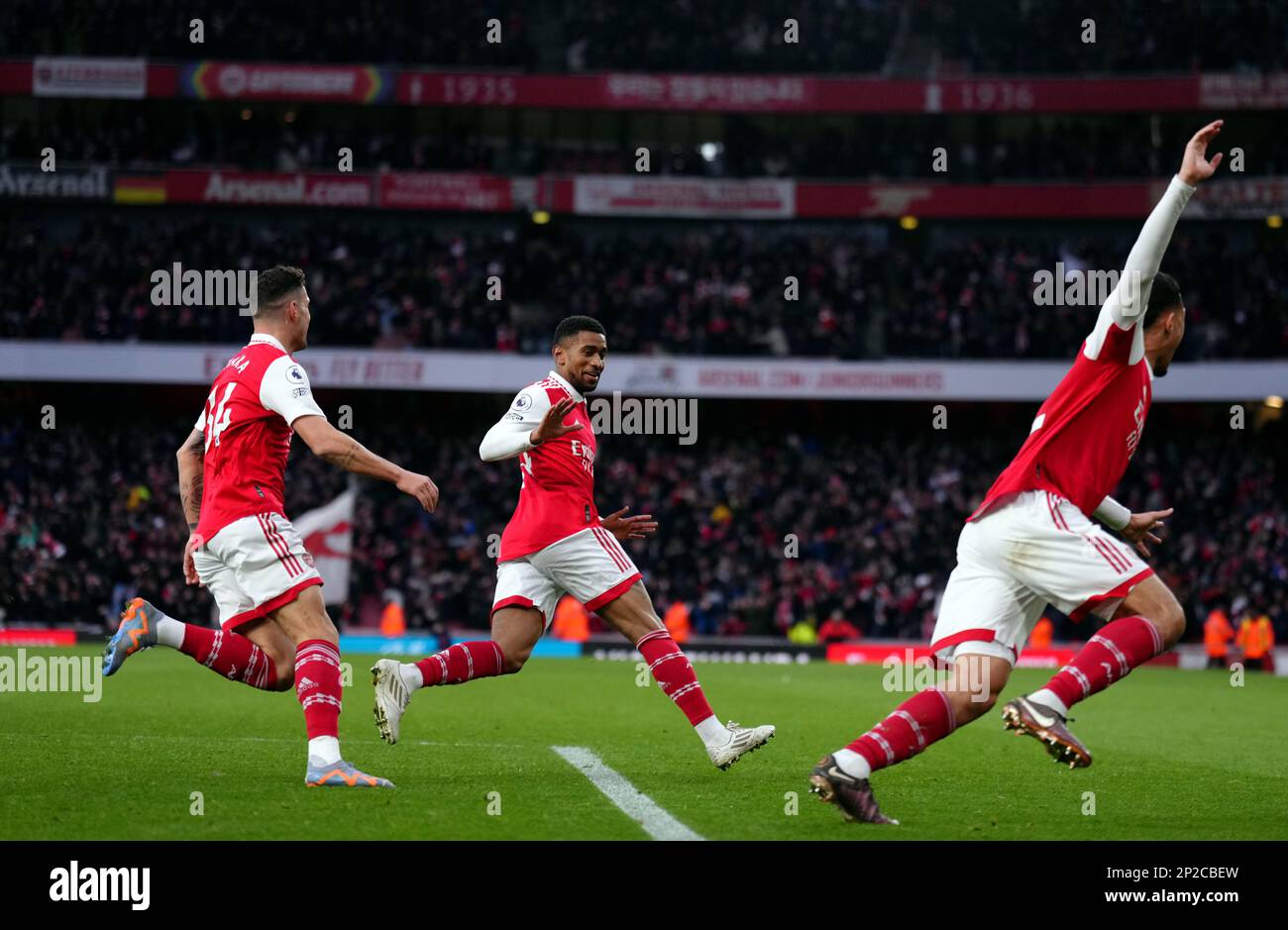 Arsenal's Reiss Nelson (centre) celebrates scoring his sides third goal ...