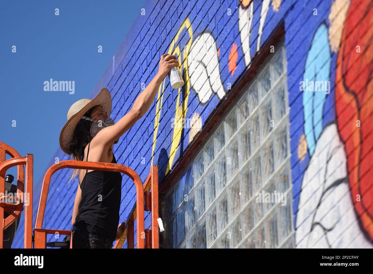 Detroit-based artist Ouizi works on her mural in Detroit's historic Eastern Market Tuesday Sept ...