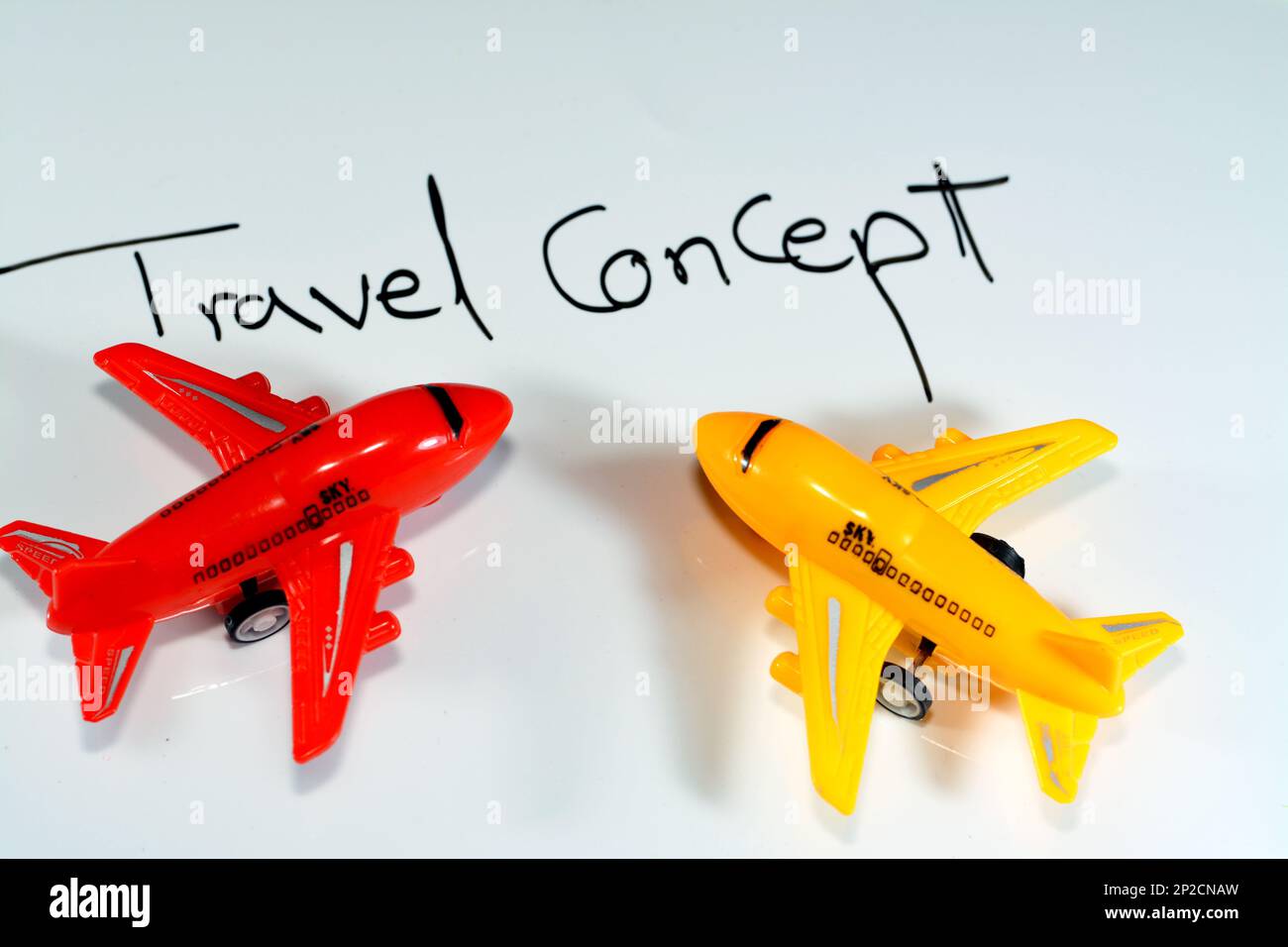 English text on a board ( Travel concept ) with a small airplane beside ...