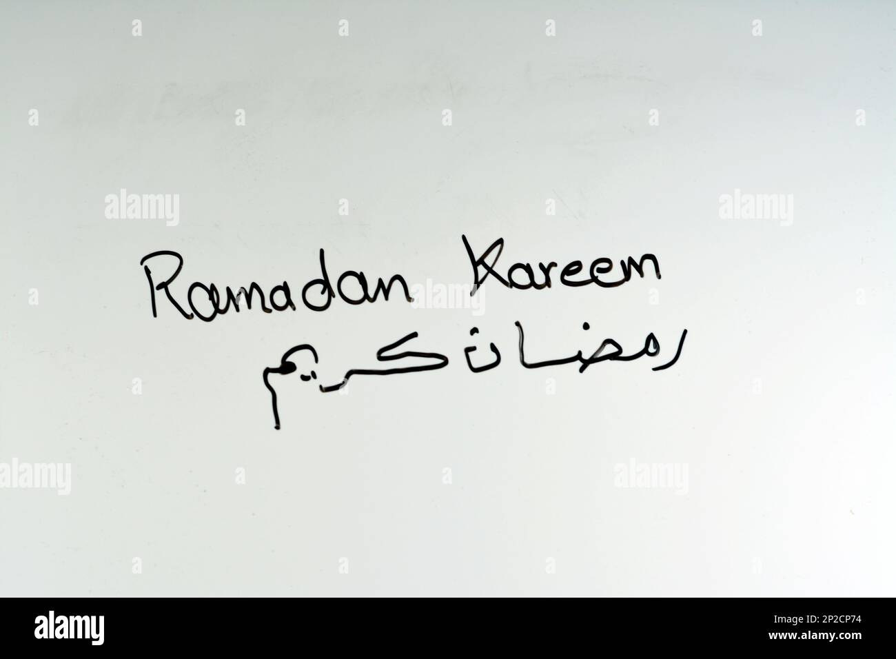 Ramadan Kareem text in Arabic and English handwritten on a board as a ...