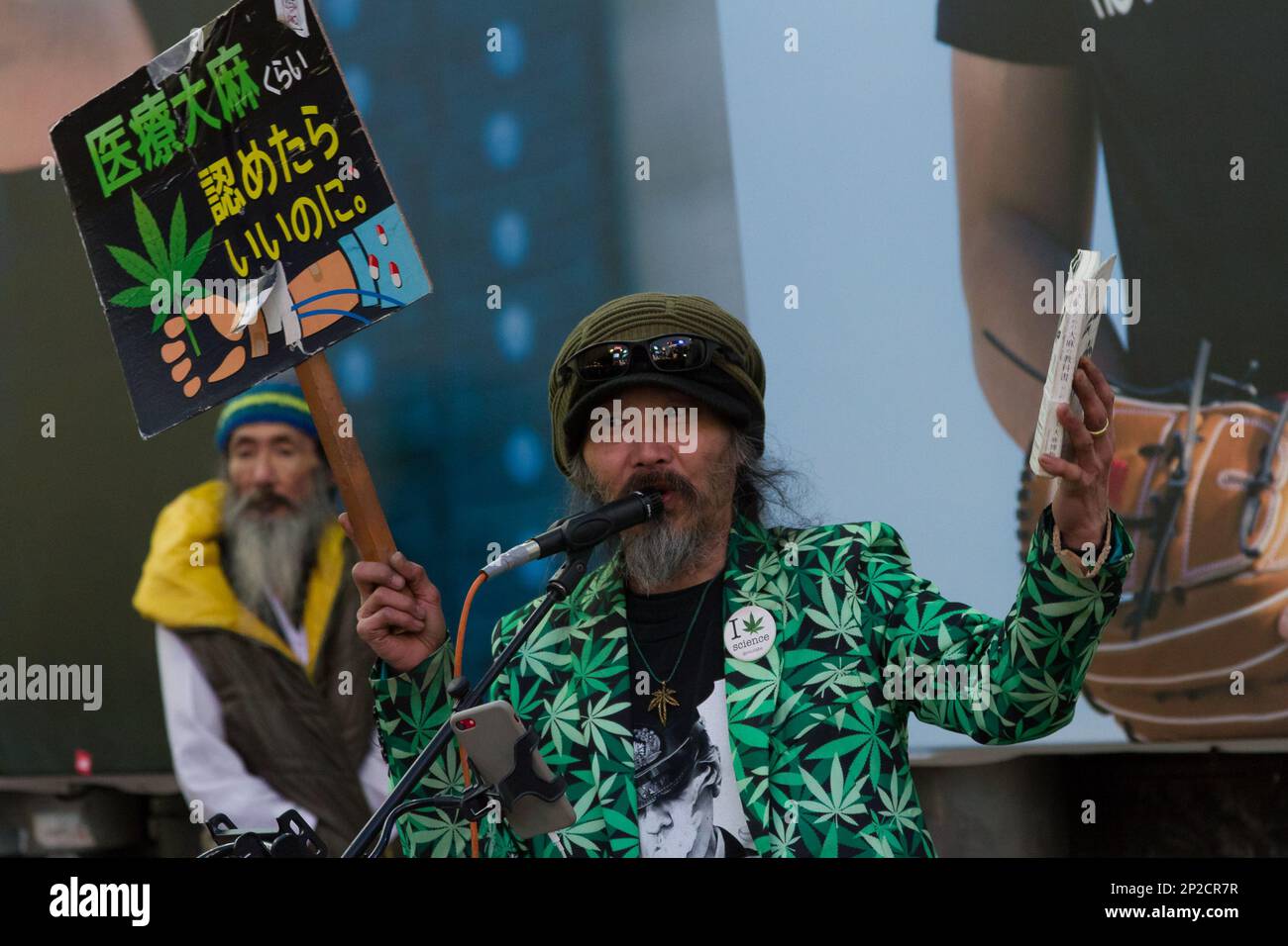 A dreadlocked Japanese man holds a placard calling for the legalisation ...