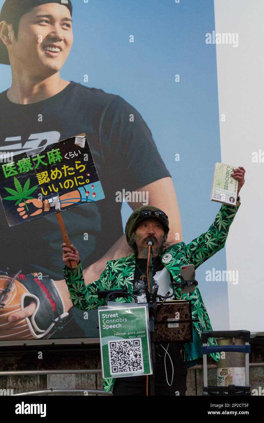 A dreadlocked Japanese man holds a placard calling for the legalisation ...