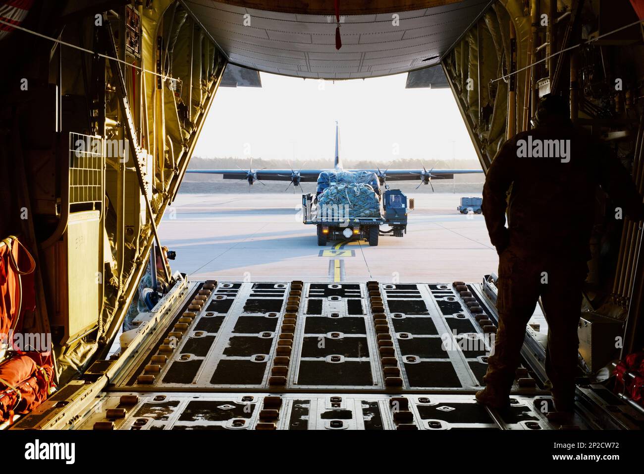 U.S. Air Force Airmen load cargo on a C-130J Super Hercules aircraft at ...