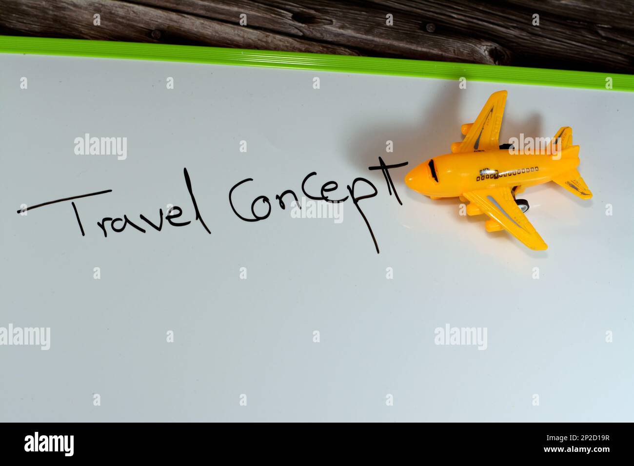 English text on a board ( Travel concept ) with a small airplane beside ...