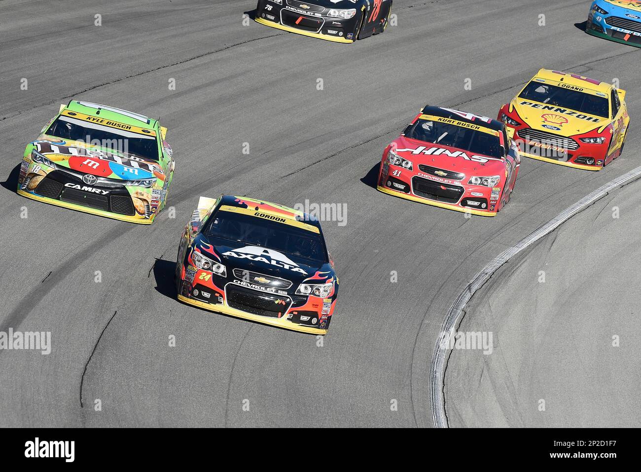 Jeff Gordon (24) leads the field, followed by Kyle Busch, while racing ...