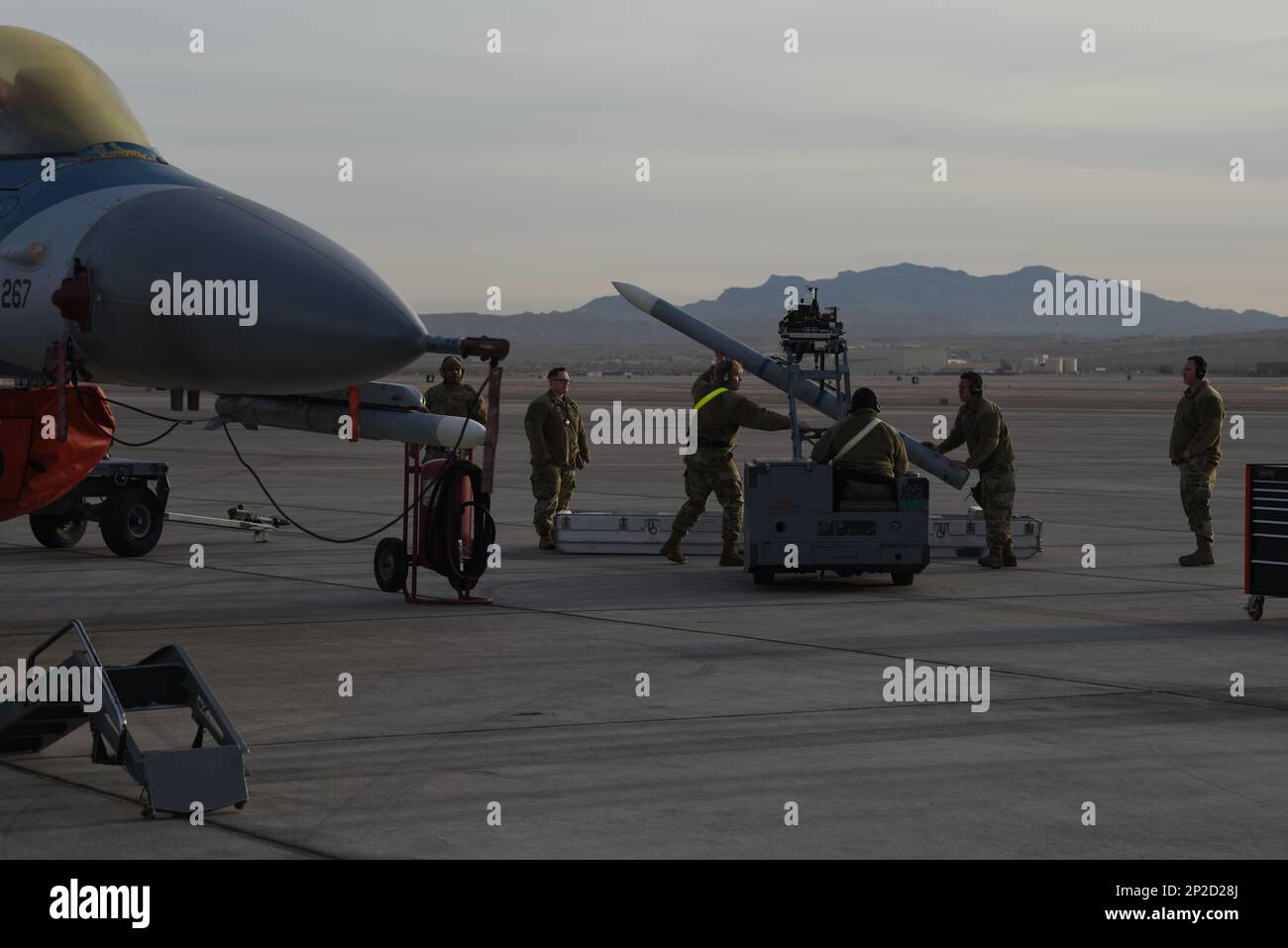 U.S. Air Force weapons load crew from the 57th Maintenance Group ...