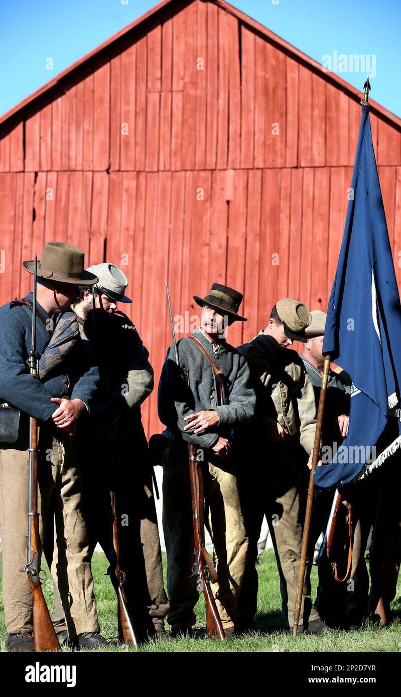 Civil War re-enactor Brandon Booth, of New Market, Md., center, stands ...