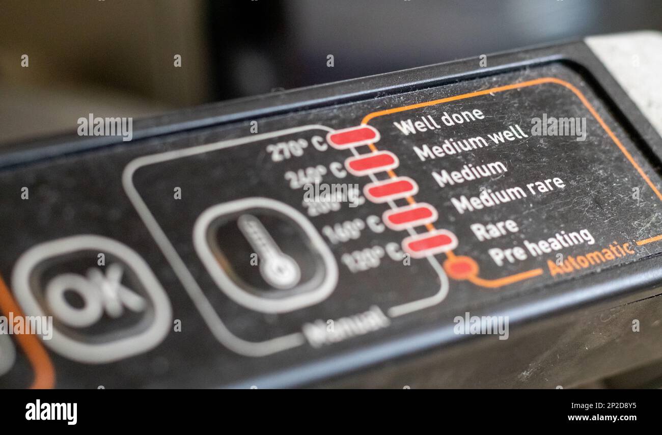 Electric grill power adjustment indicators and power button. The degree ...