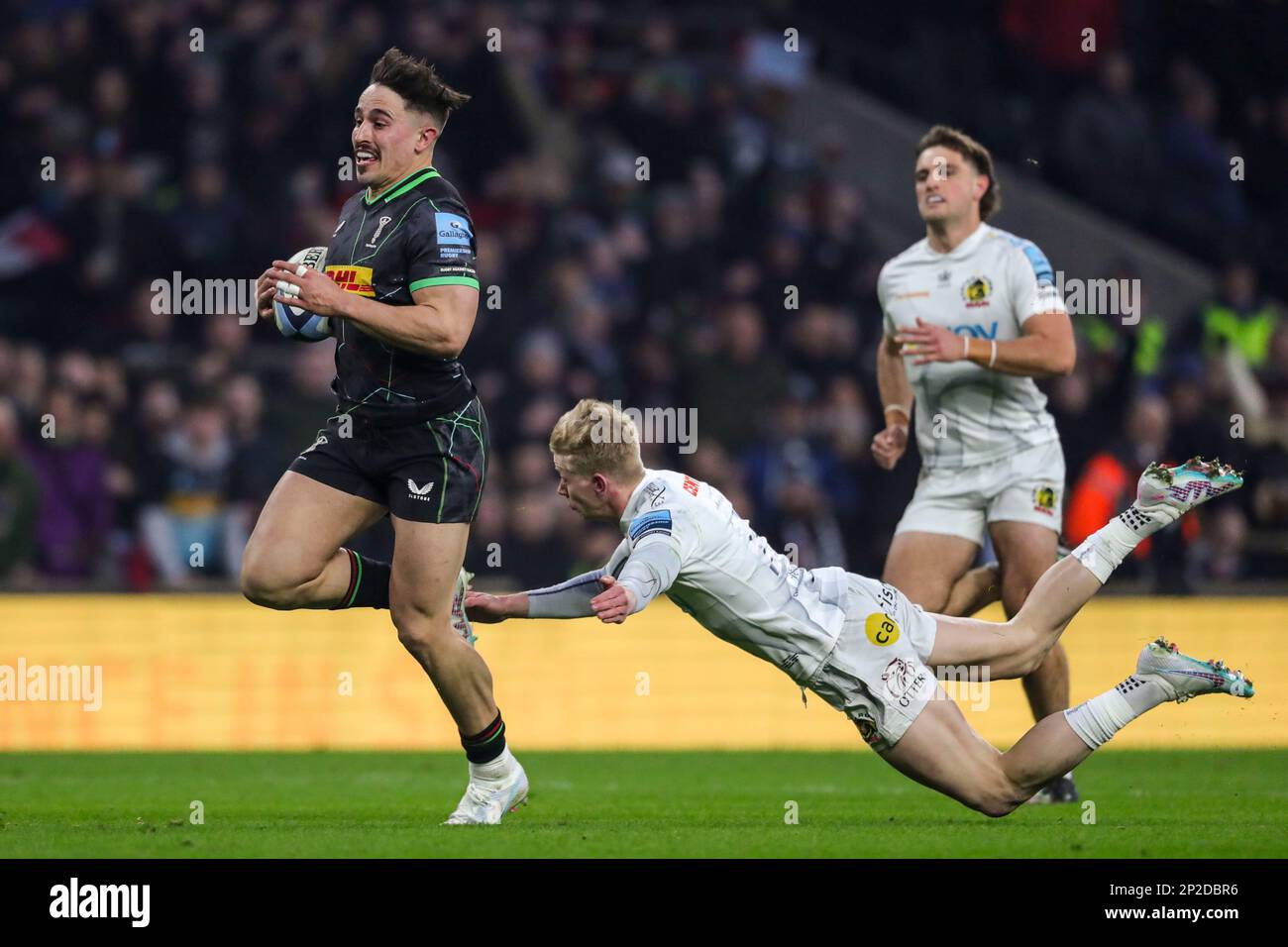 Harlequins' Cadan Murley (left) gets past Exeter Chiefs' Josh Hodge on ...