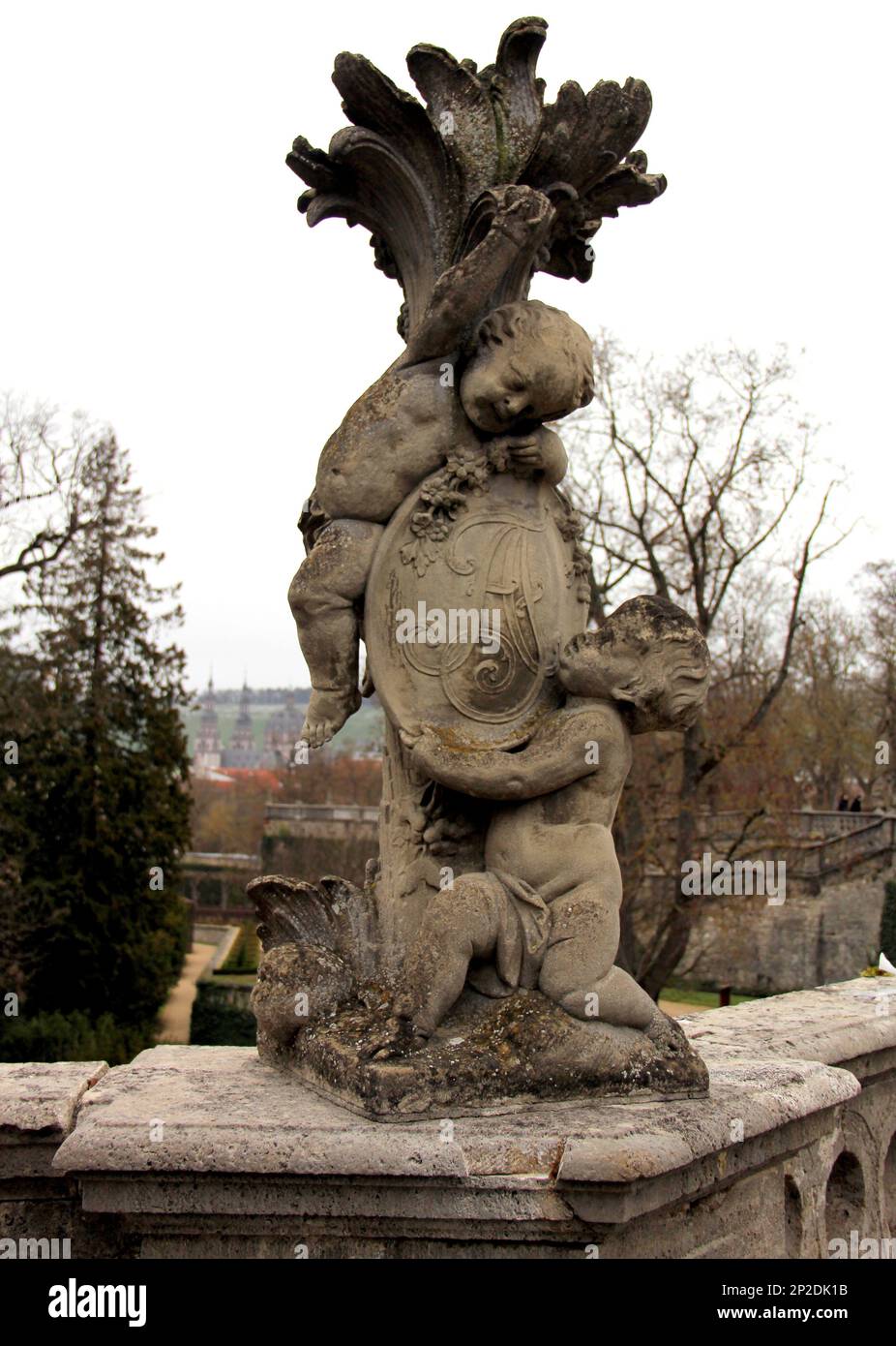 Sculpture of putti holding cartouche with a monogram, in the Court ...