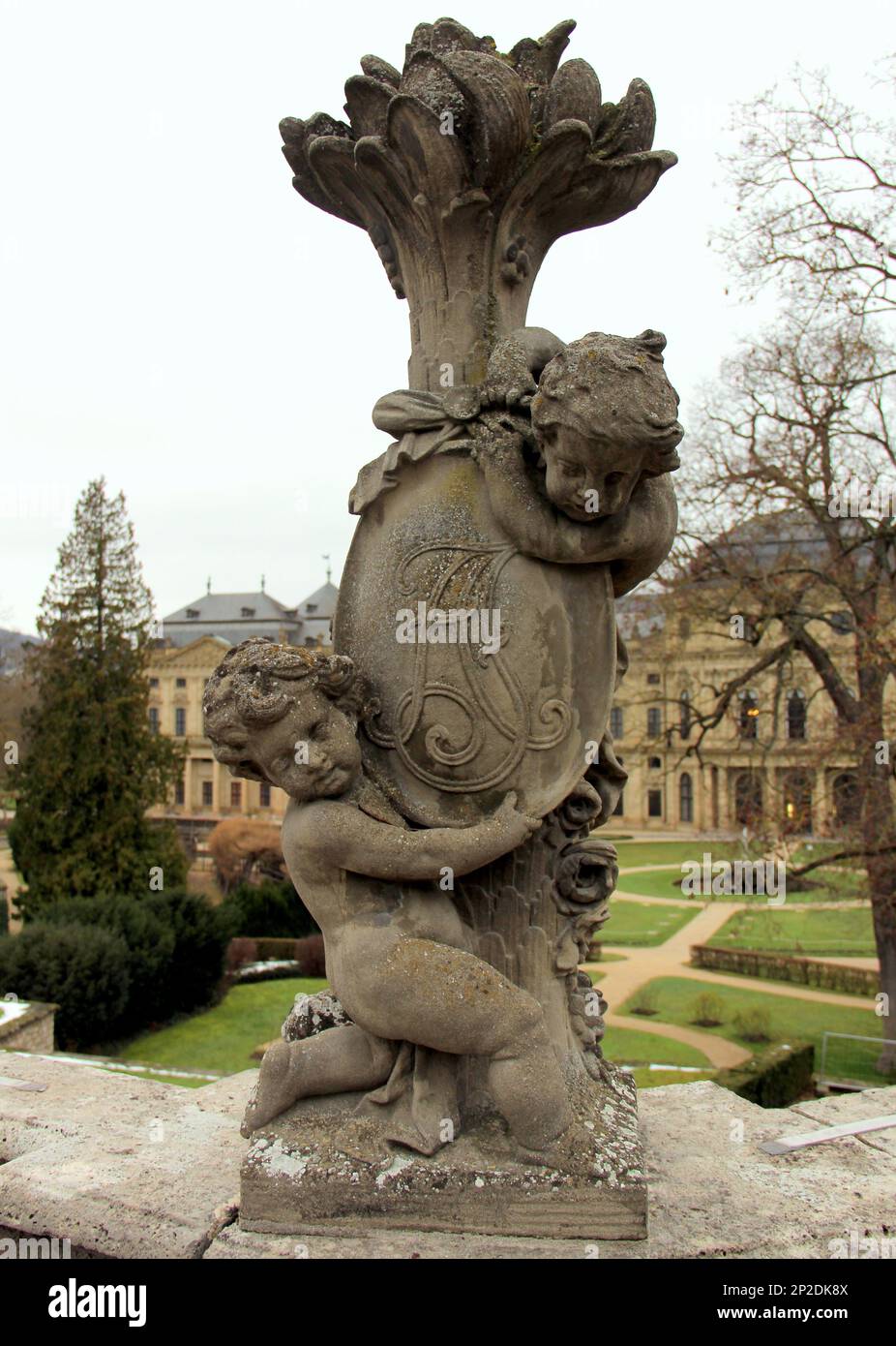 Sculpture of putti holding cartouche with a monogram, in the Court ...