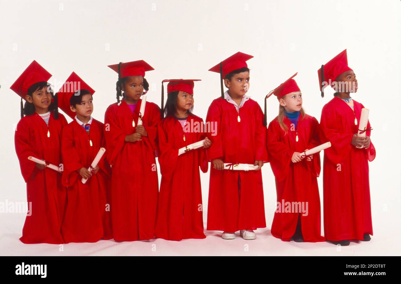 Line of children dressed in red cap and gowns holding diplomas, all ...