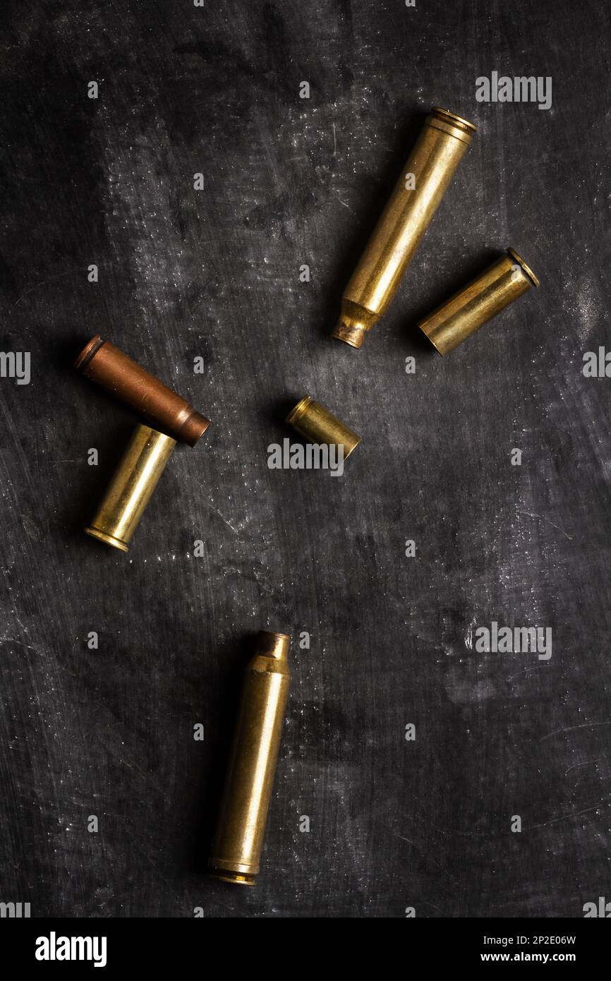 Empty bullet cartridges lying on the black background Stock Photo - Alamy