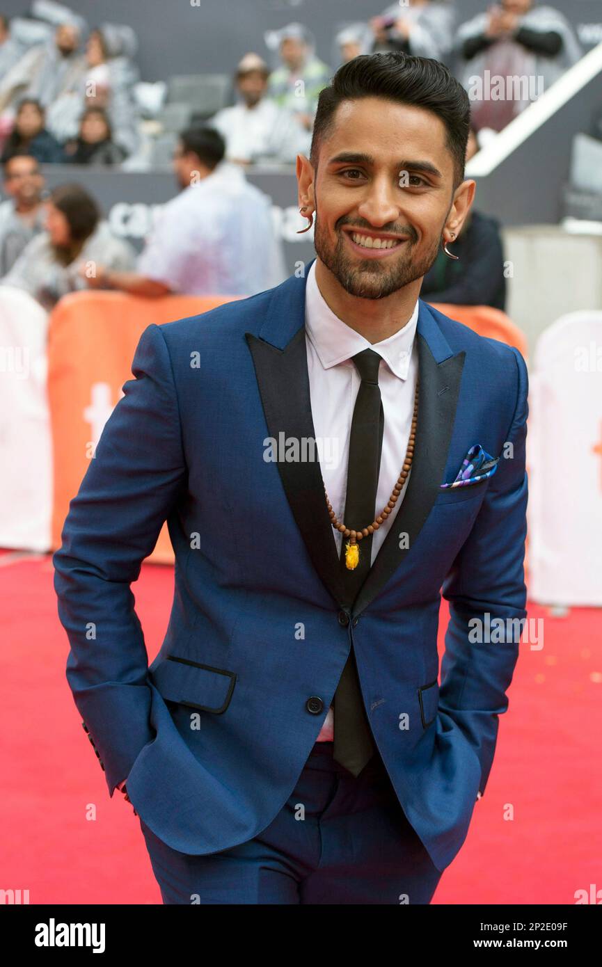 Ali Momen poses for photos on the red carpet at the gala for the film ...