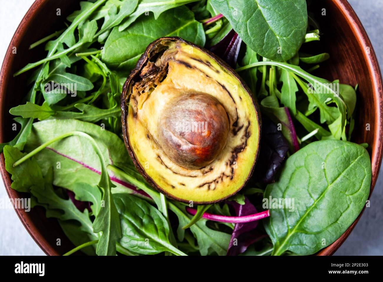 Rotten avocado, overriped, bad avocado. Half sliced fruit, freegan food ...