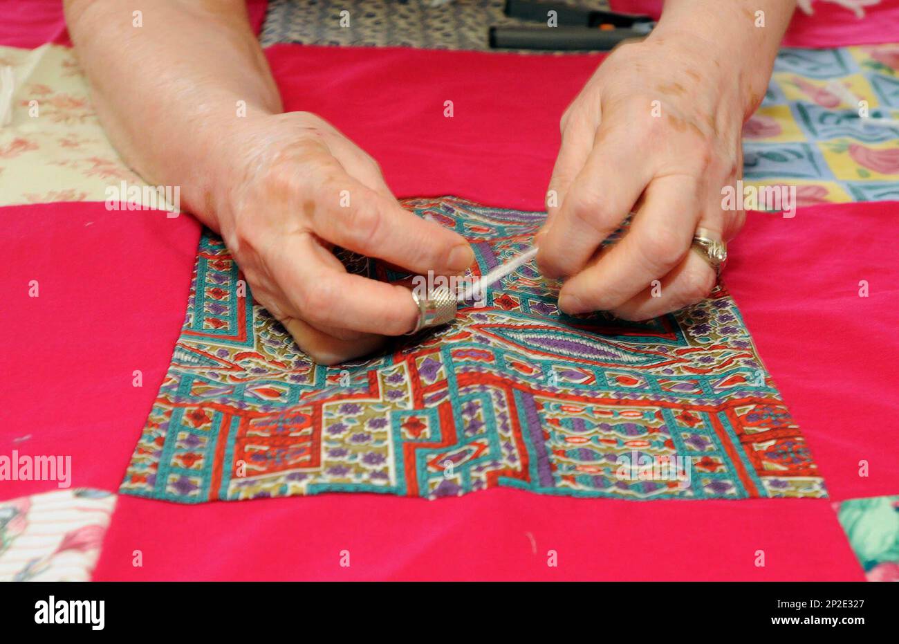 In this Aug. 11, 2015 photo, a quilter secures the center of a square ...
