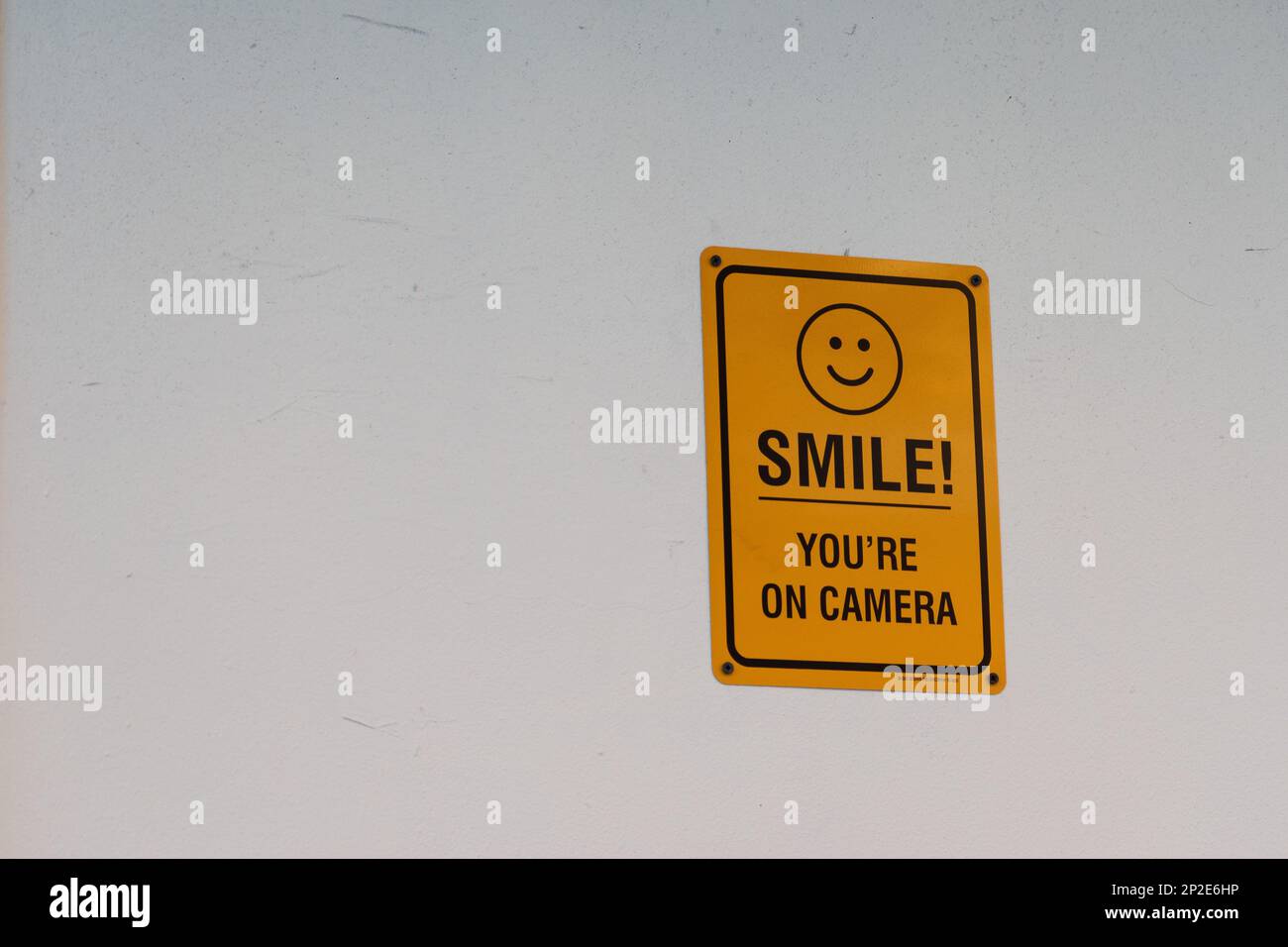 A cheerful yellow sign with an encouraging message of 'Smile, you're on ...