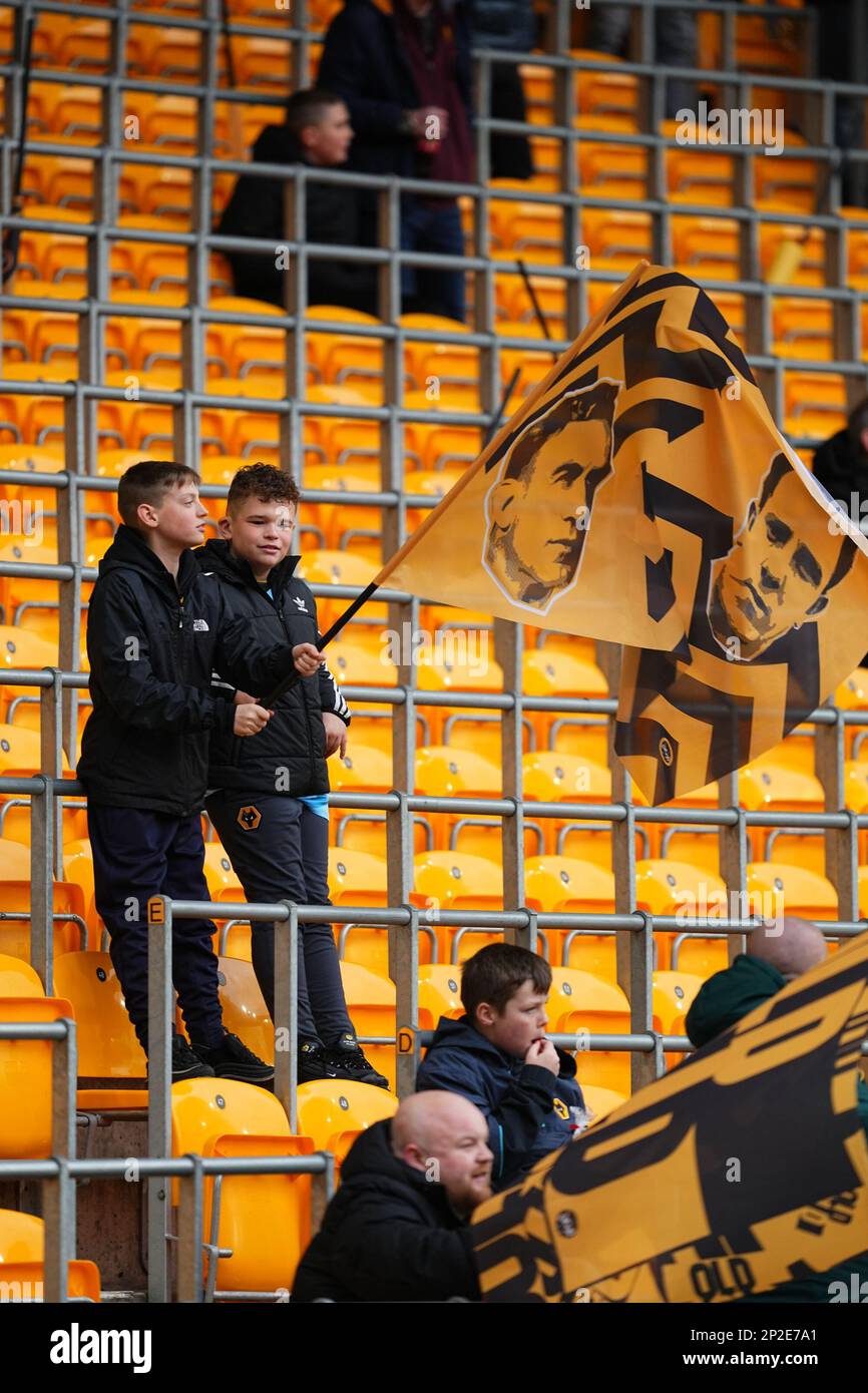 Young Wolves fans wave flags before the Premier League match between ...