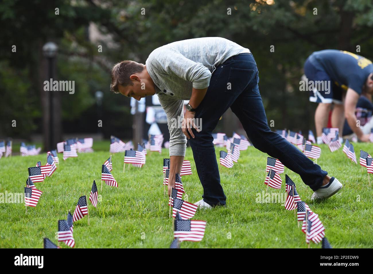 Michigan sophomore Derek Lowen places one of 2,977 small American flags ...