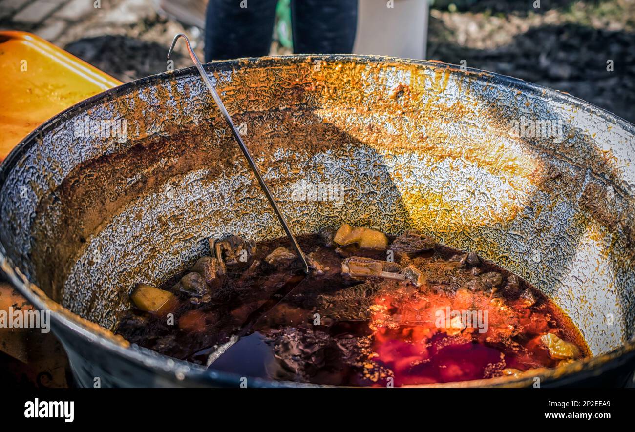 Serbian traditional stew cooked in big pots Stock Photo - Alamy