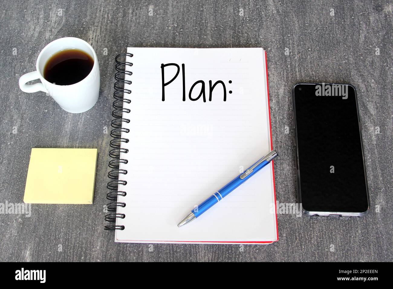 Notepad with message in spanish laguage "Plan" coffee cell pen and ...