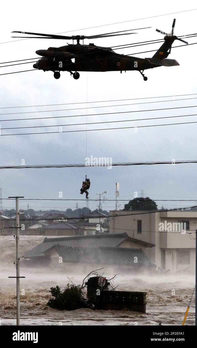 A man is rescued by a helicopter of the Japan Self-Defense Force from a ...