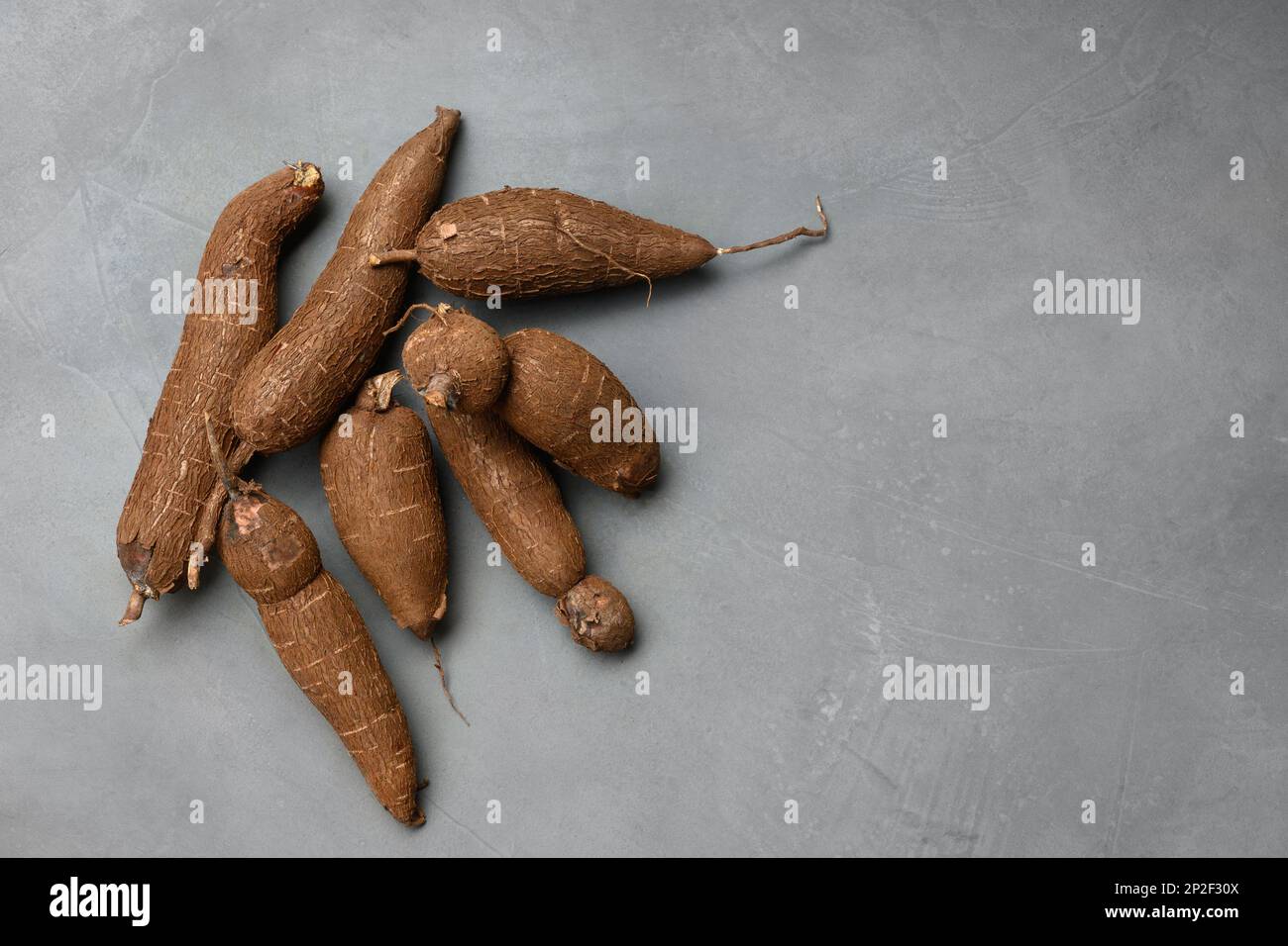 Organic Cassava tuber on gray background. View from above. Copy space ...