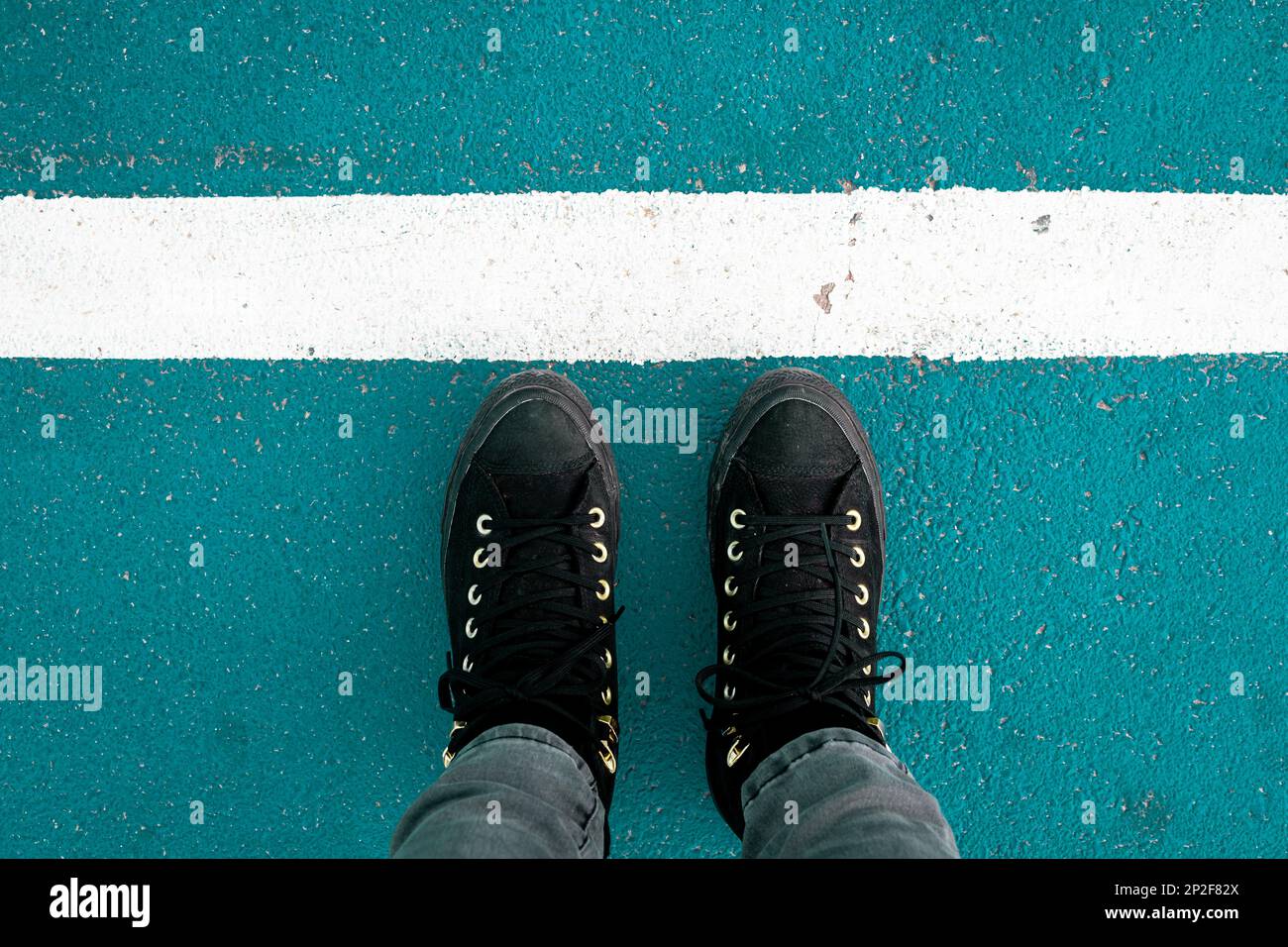 One person standing next to a white line. Separation, border Stock ...