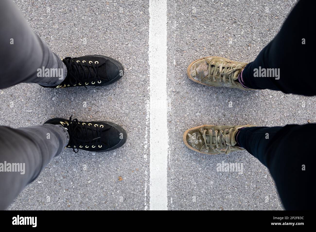 Two people separated by a white line. Separation, border Stock Photo ...
